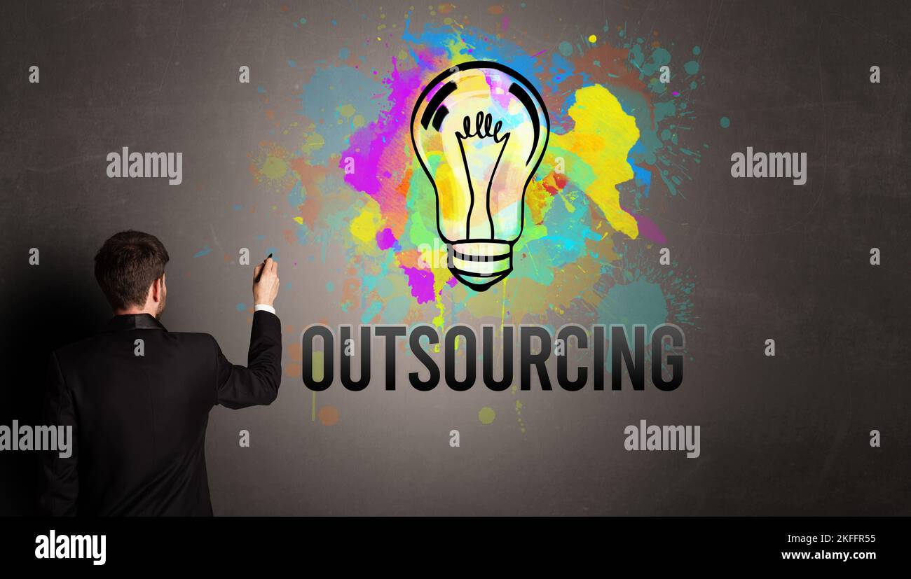 businessman drawing colorful light bulb Stock Photo - Alamy