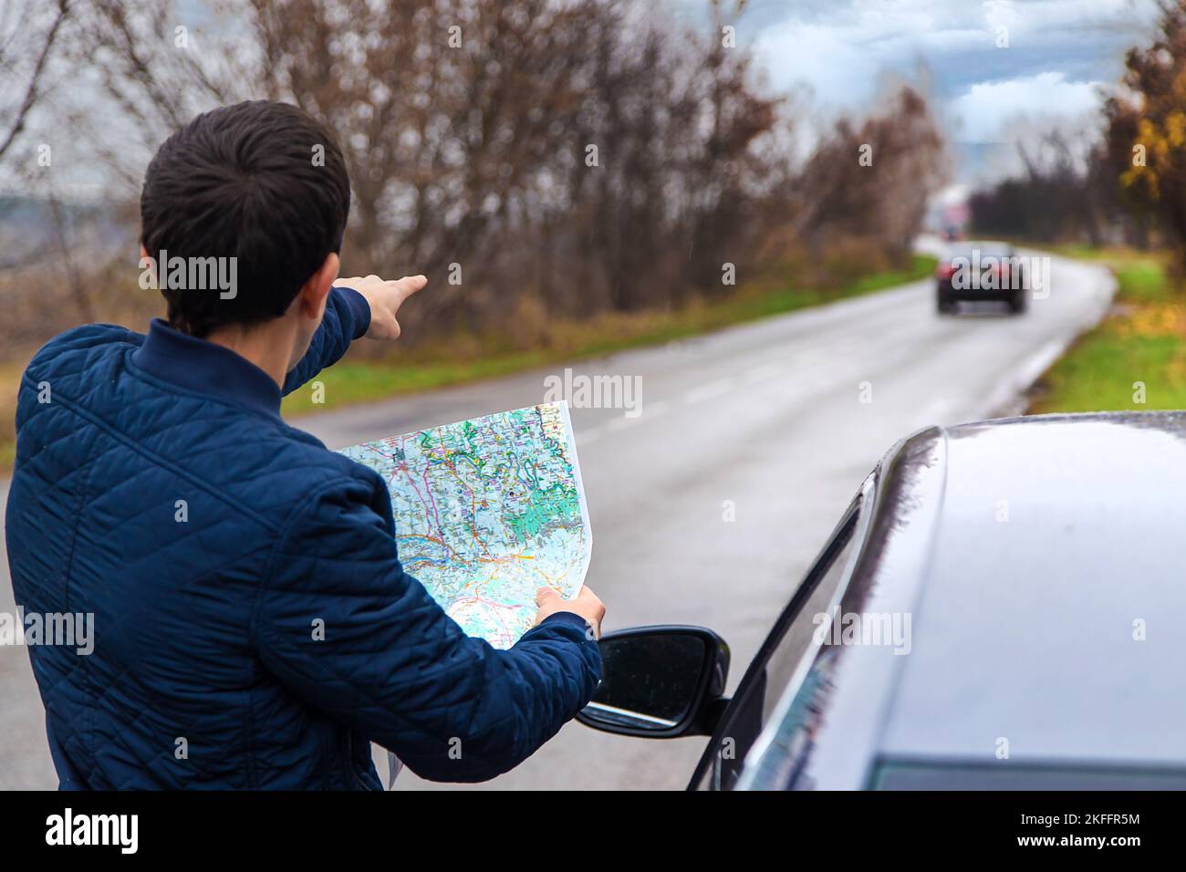 Young traveler on road trip reading map hi-res stock photography and ...