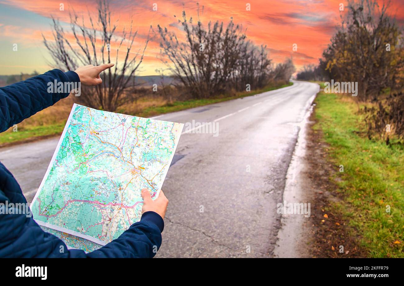 Man on road looks map hi-res stock photography and images - Alamy