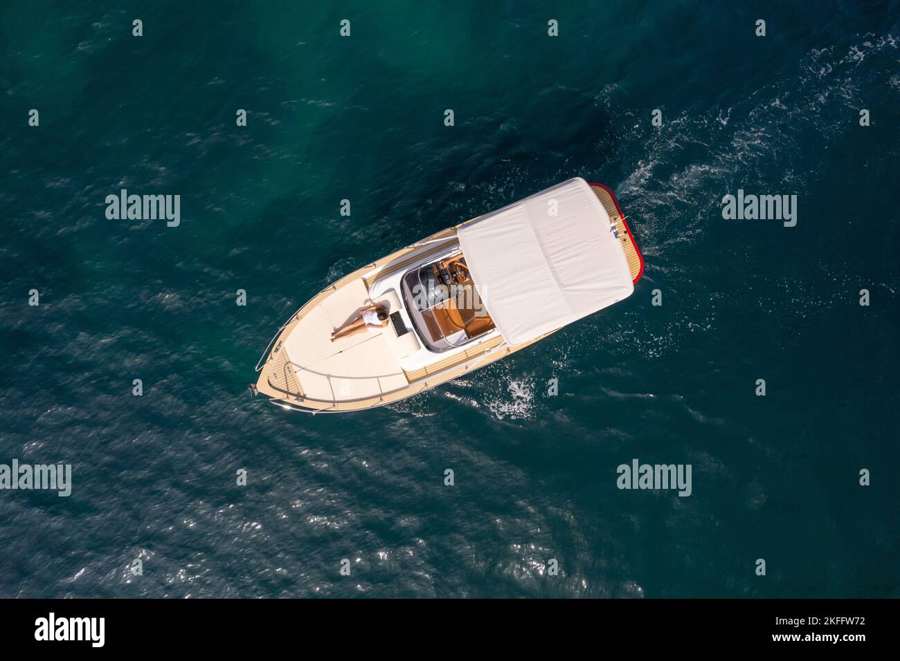 Drone top view of a little luxury boat sailing Stock Photo - Alamy