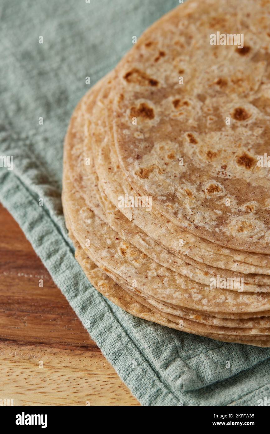 A vertical shot of a thin tortilla flatbread stack on a cloth Stock ...