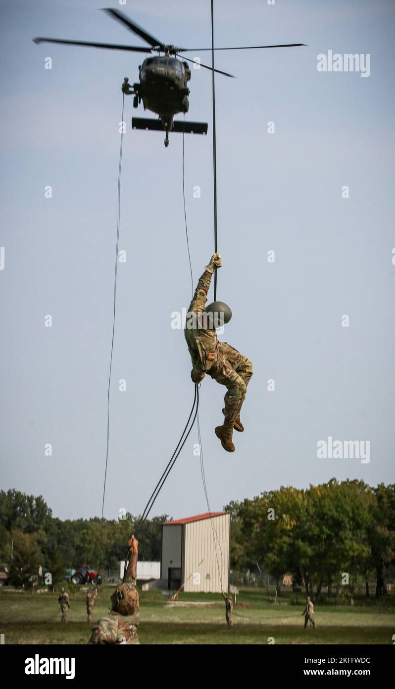 A U.S. Soldier rappels from a UH-60 Black Hawk helicopter at Camp Dodge ...