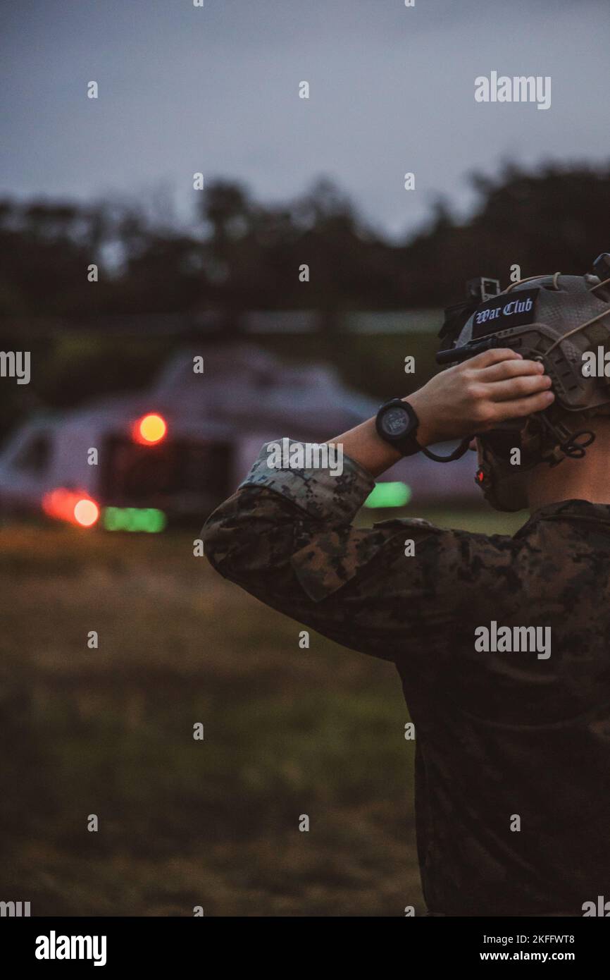 A U.S. Marine with III Marine Expeditionary Force (MEF) observes a UH ...