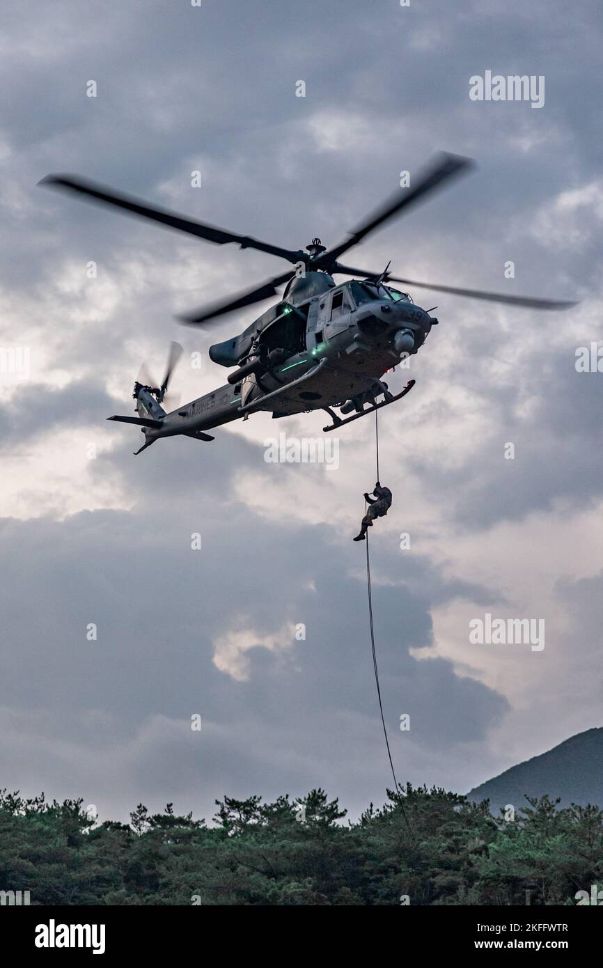 U.S. Marines with III Marine Expeditionary Force (MEF) repel from a UH ...
