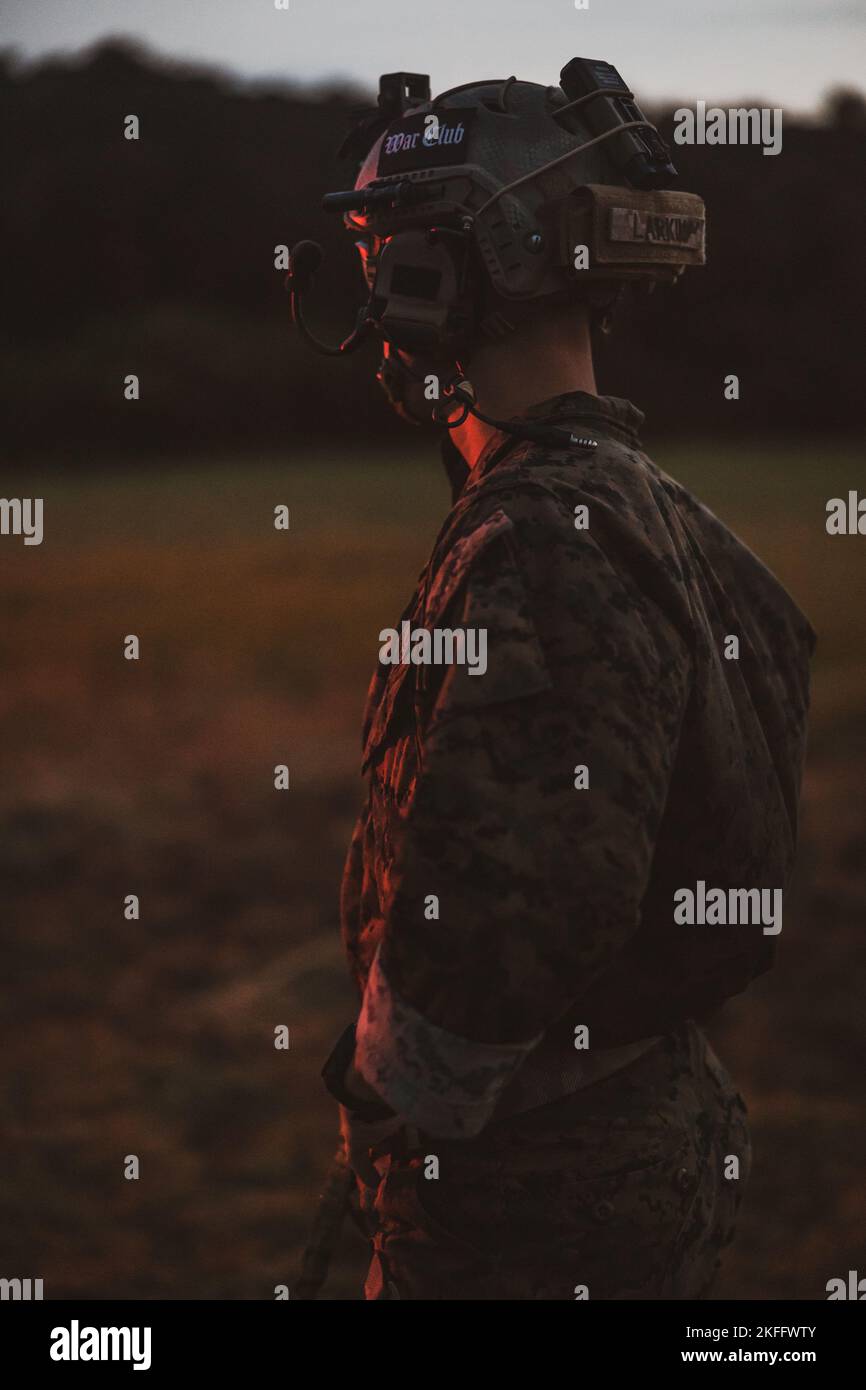 A U.S. Marine with III Marine Expeditionary Force (MEF) observes a UH ...