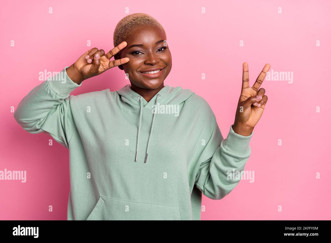 Photo of young female with short fair hair showing v sign make dancing ...