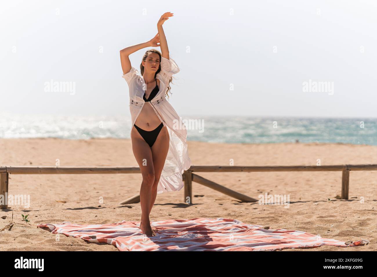 A View A Young And Beautiful Spanish Woman In A Bikini And White Robe