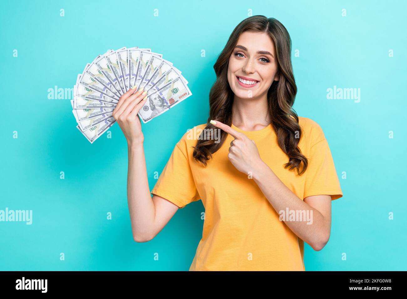 Photo of young confident positive cute lady woman hold money finger ...
