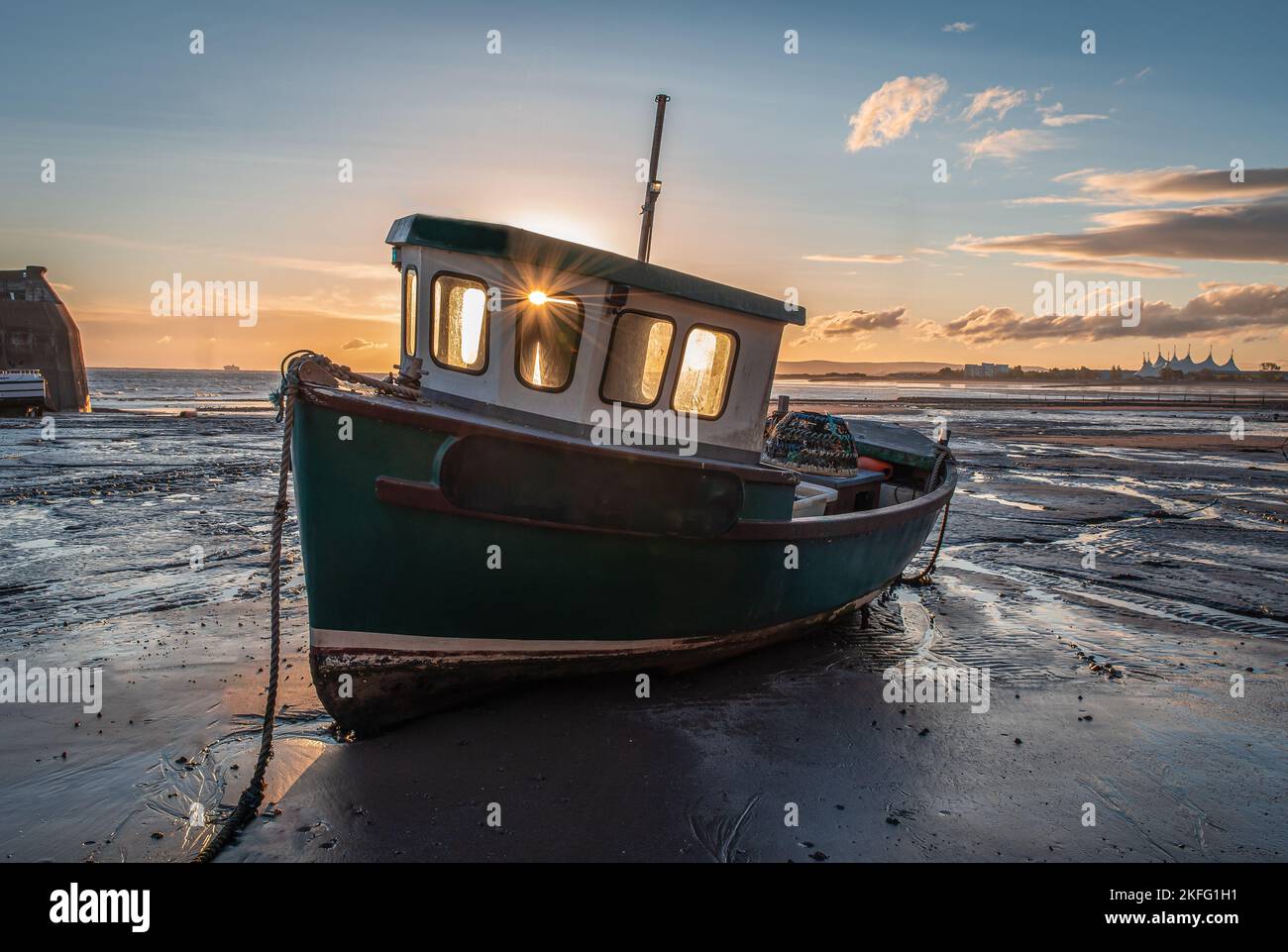 A fishing boat in Minehead Quay at low tide and sunrise Stock Photo - Alamy