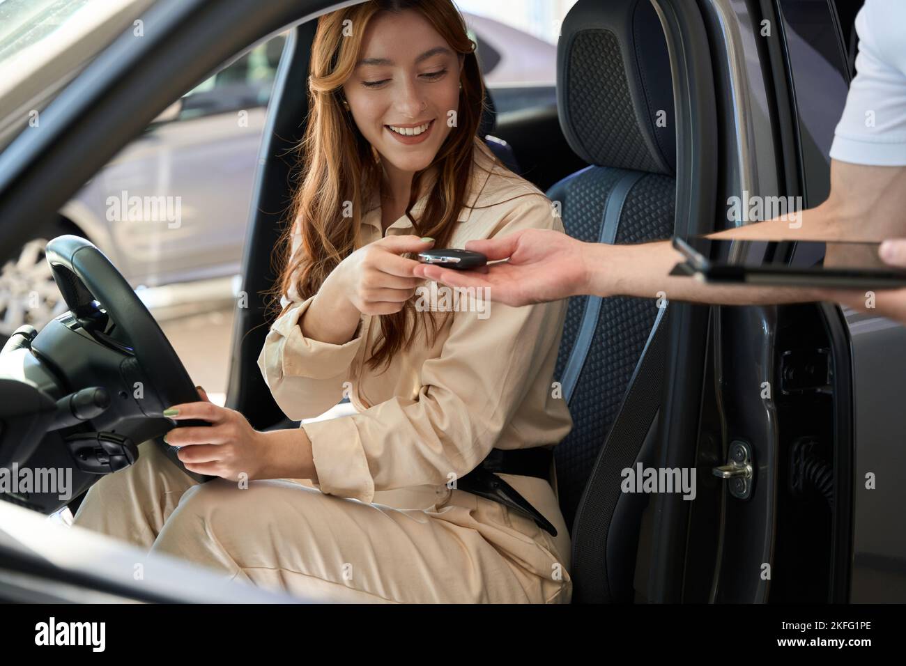 Automobile dealership client receiving auto remote control unit from ...