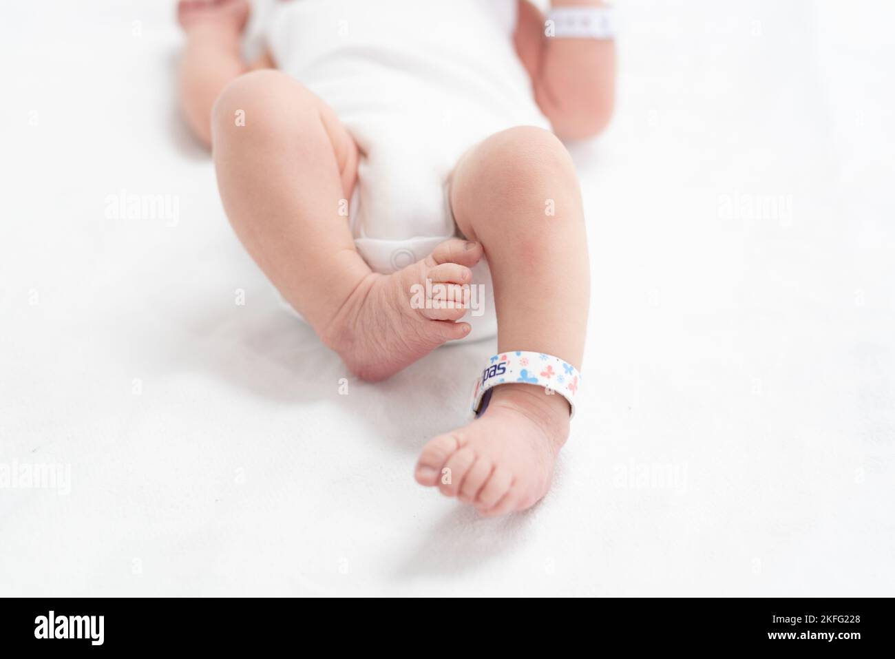A newborn baby in hospital being cleaned up by a doctor after birth ...