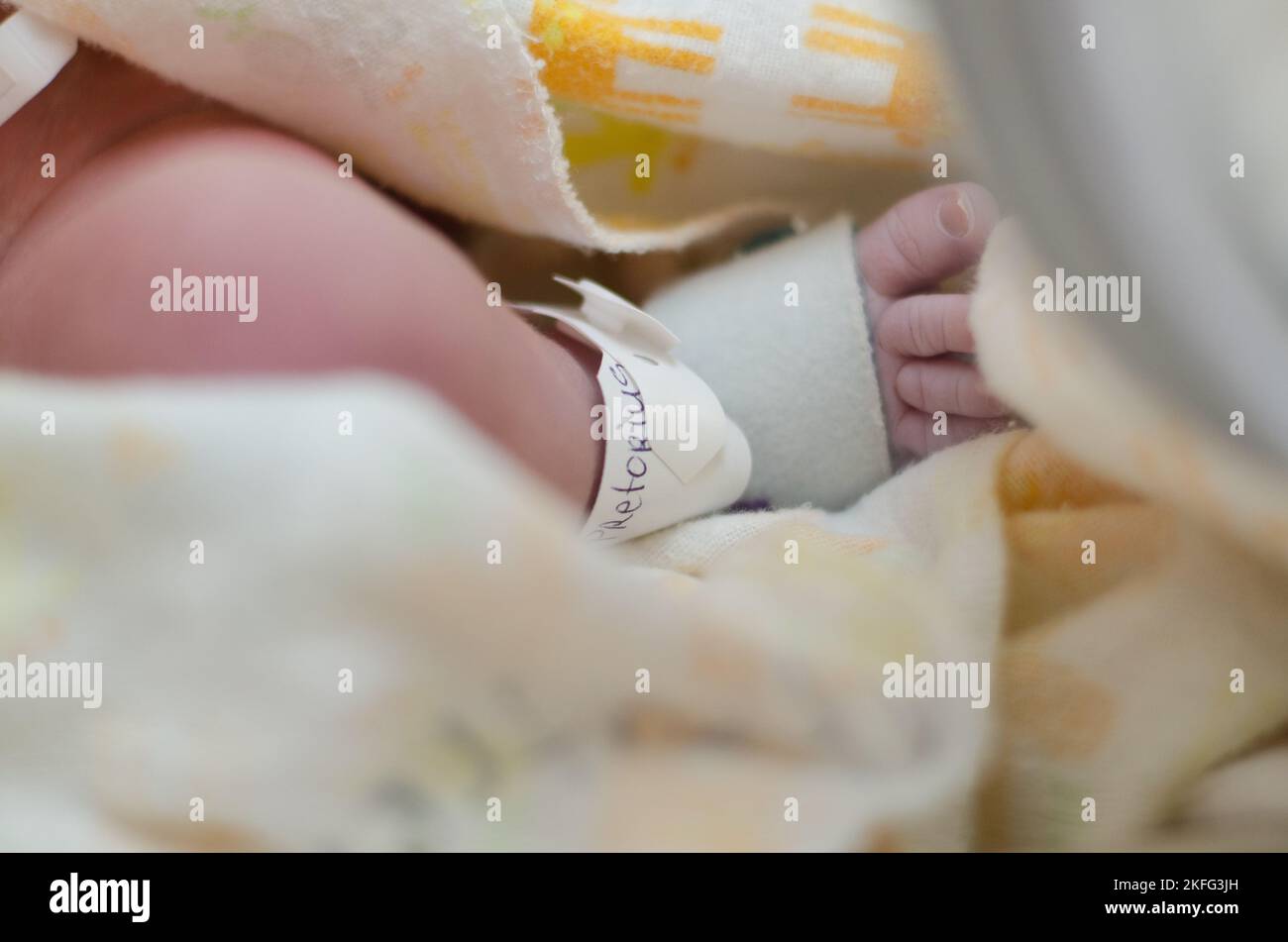 A newborn baby in hospital being cleaned up by a doctor after birth ...
