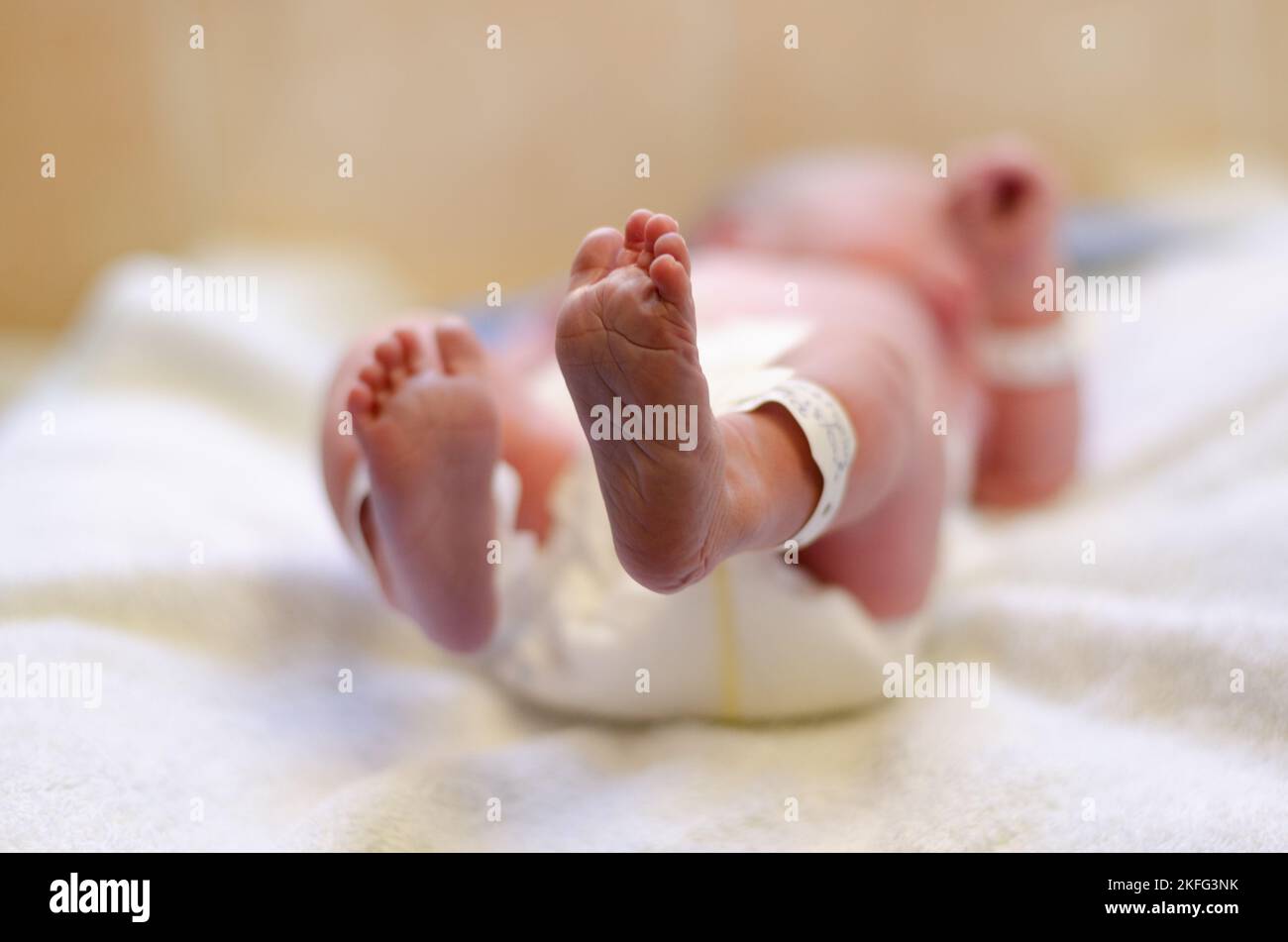 A newborn baby in hospital being cleaned up by a doctor after birth ...