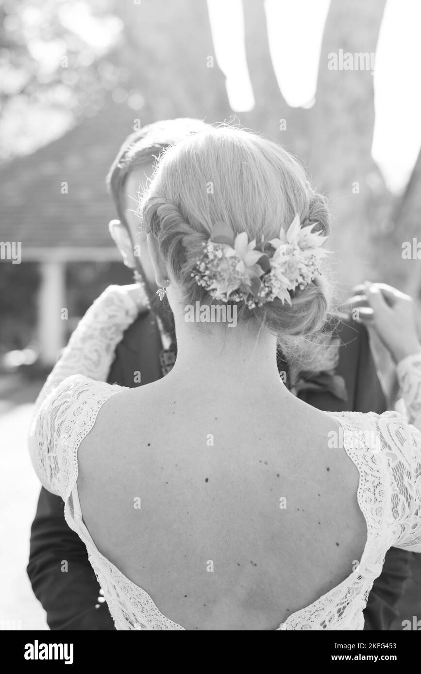 A bride and groom standing together at the ceremony of their wedding ...