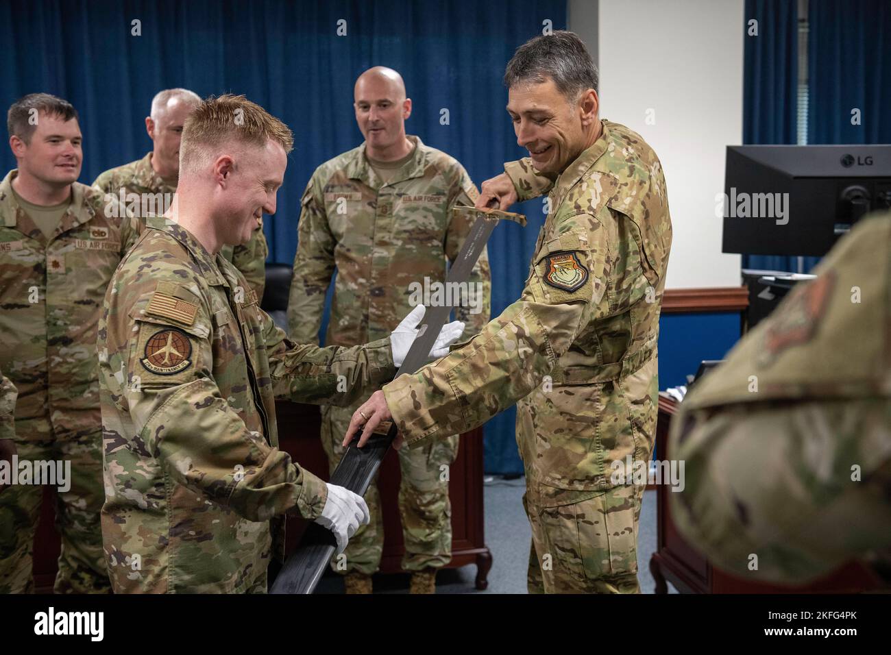 Col. Andrew Roddan, 374th Airlift Wing Commander, sheathes the Wing ...