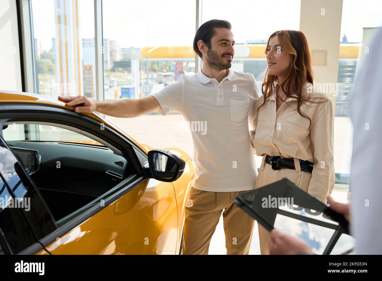 Romantic couple choosing new vehicle at dealership Stock Photo - Alamy