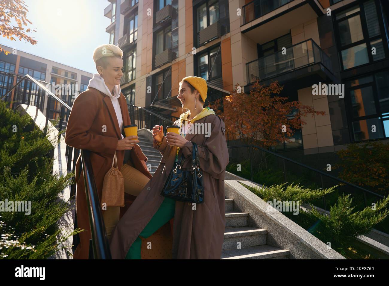 Female lgbt couple stands on the background of autumn cityscape Stock ...