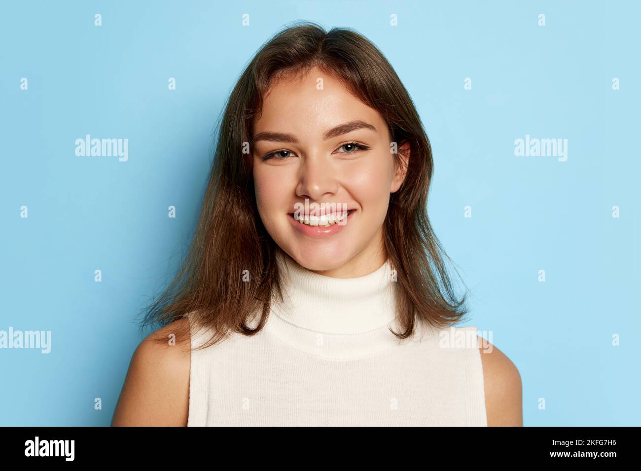 Portrait of young beautiful woman posing, smiling at camera isolated ...