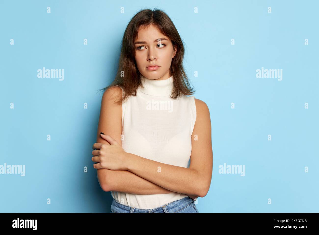 Portrait of young beautiful woman posing with sad expression isolated ...