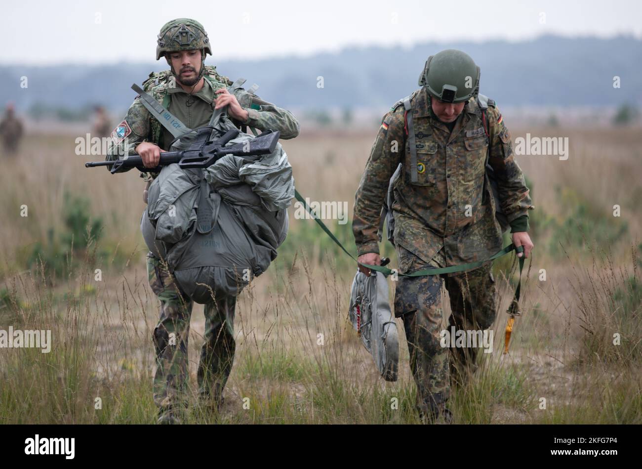 One Dutch and One German Paratrooper walks off the Drop Zone with their ...