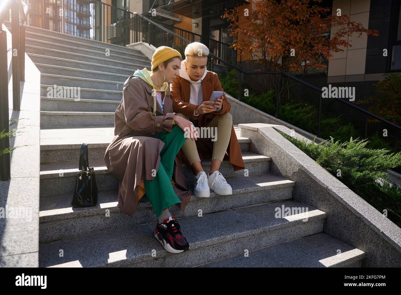 Two women are located on the stone steps Stock Photo - Alamy