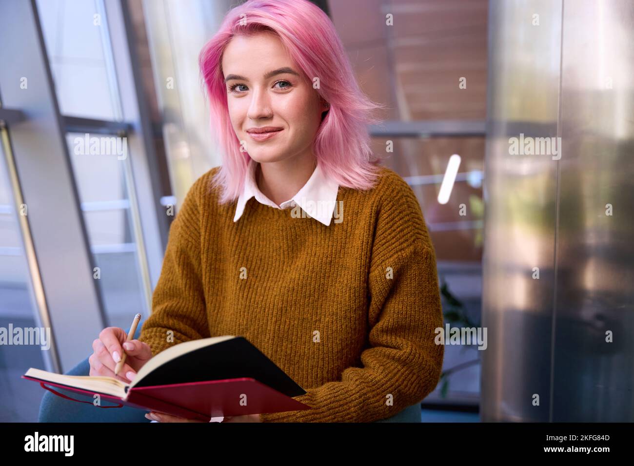 Close-up photo of woman making notes in the book Stock Photo - Alamy