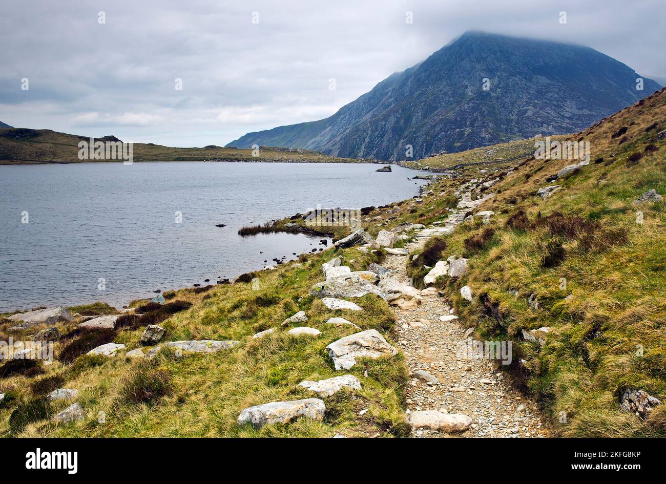 Llyn Idwal with well maintained footpath distant mountain of Pen yr Ole ...