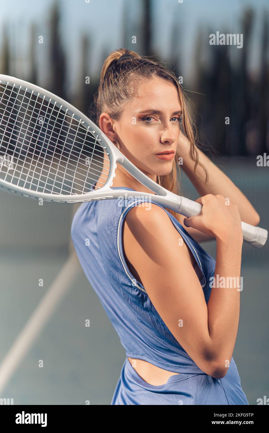 A vertical shot of a young attractive fit caucasian female posing with ...