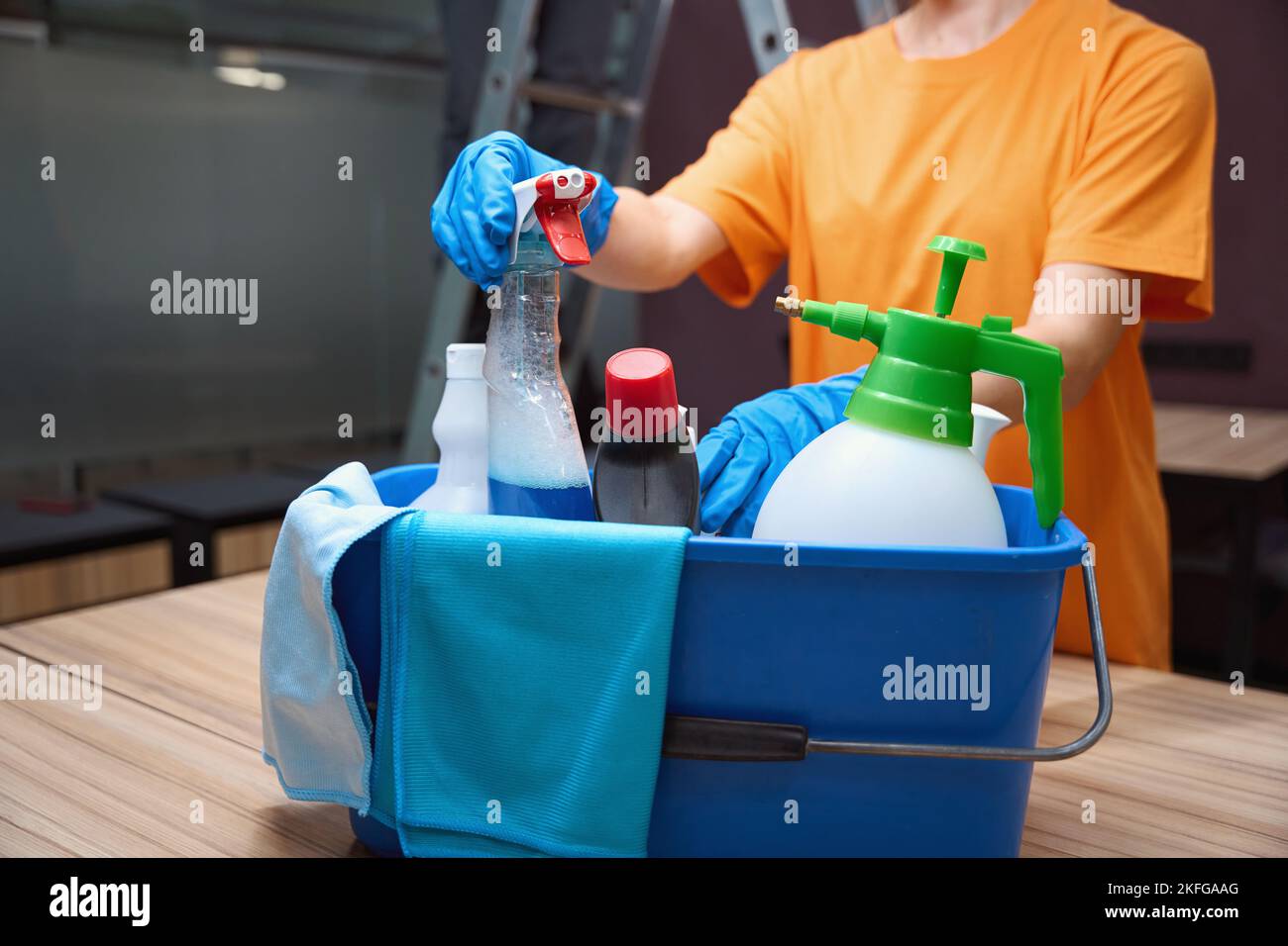 Cleaning company worker putting chemicals and tools back in box Stock ...