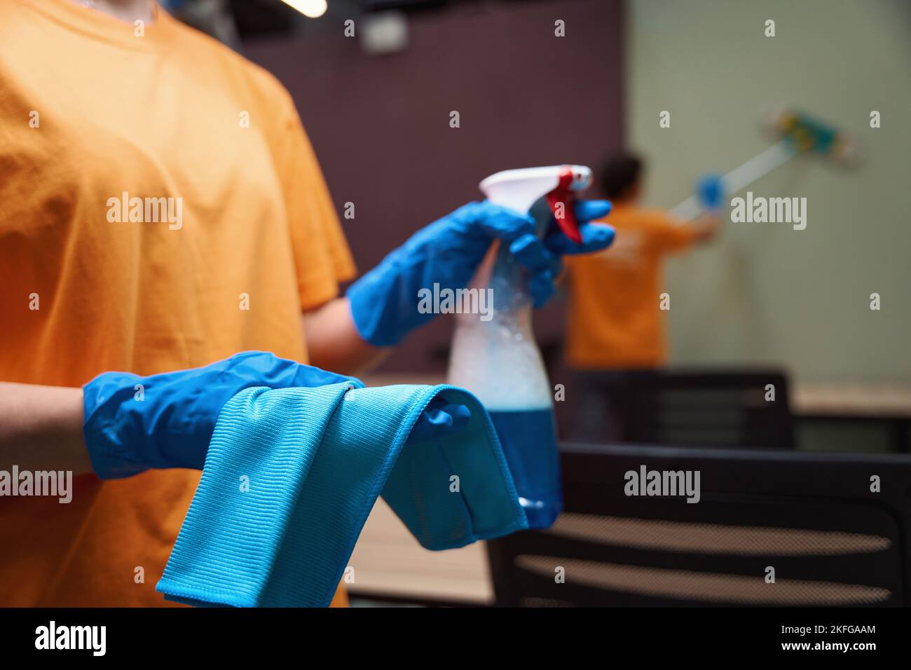 Dedicated janitor carrying disinfectant spray and wiping cloth Stock ...