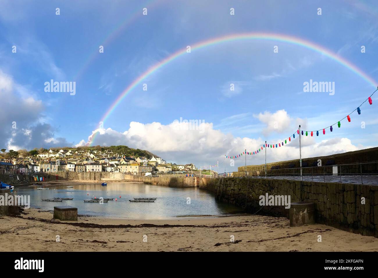 November 18th, 2022. Mousehole, Cornwall. A double rainbow appears over ...
