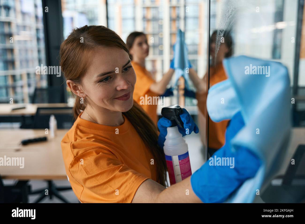 Women cleaners work in the office area in rubber gloves Stock Photo - Alamy