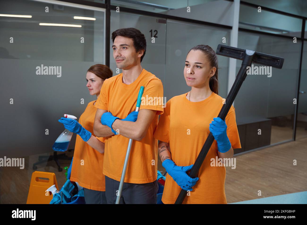 Cleaning service workers posing with their professional equipment Stock ...