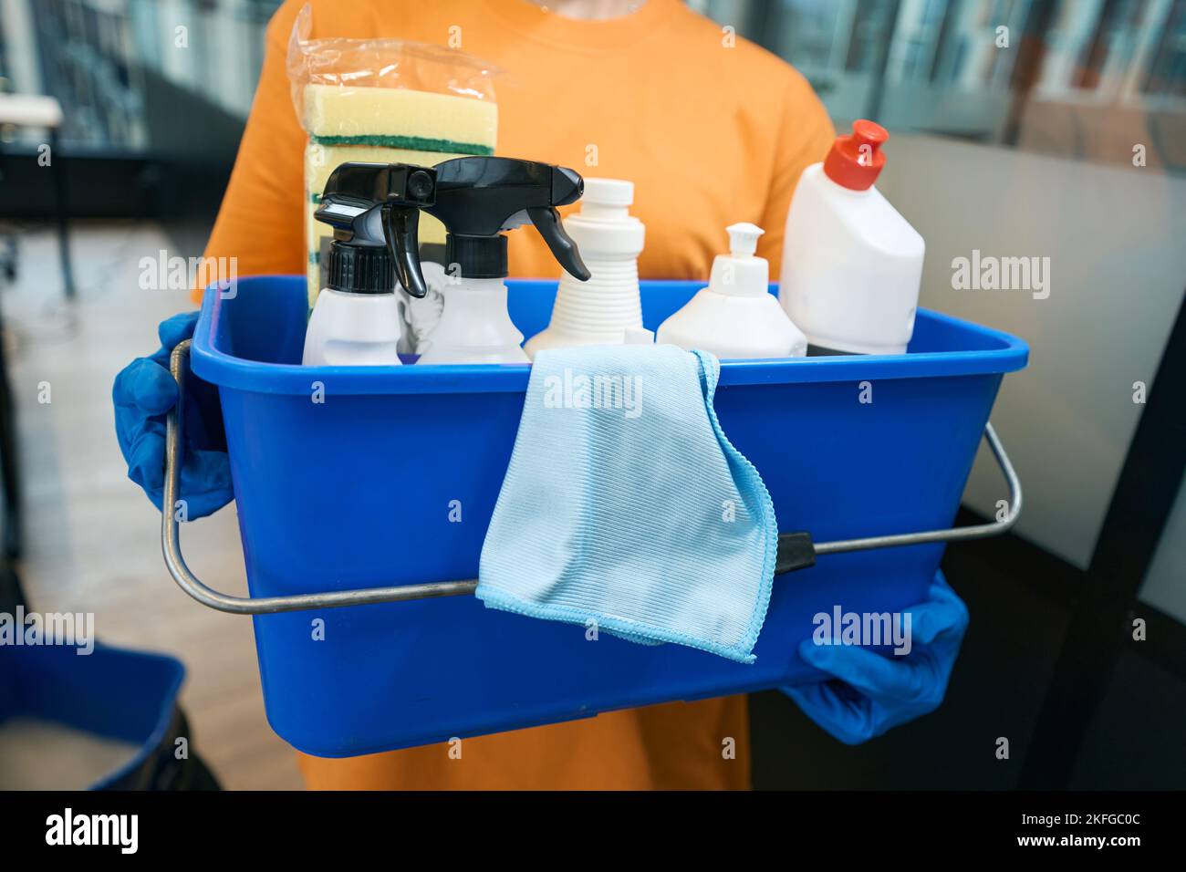 Employeecleaning service holds bucket in her hands with professional ...