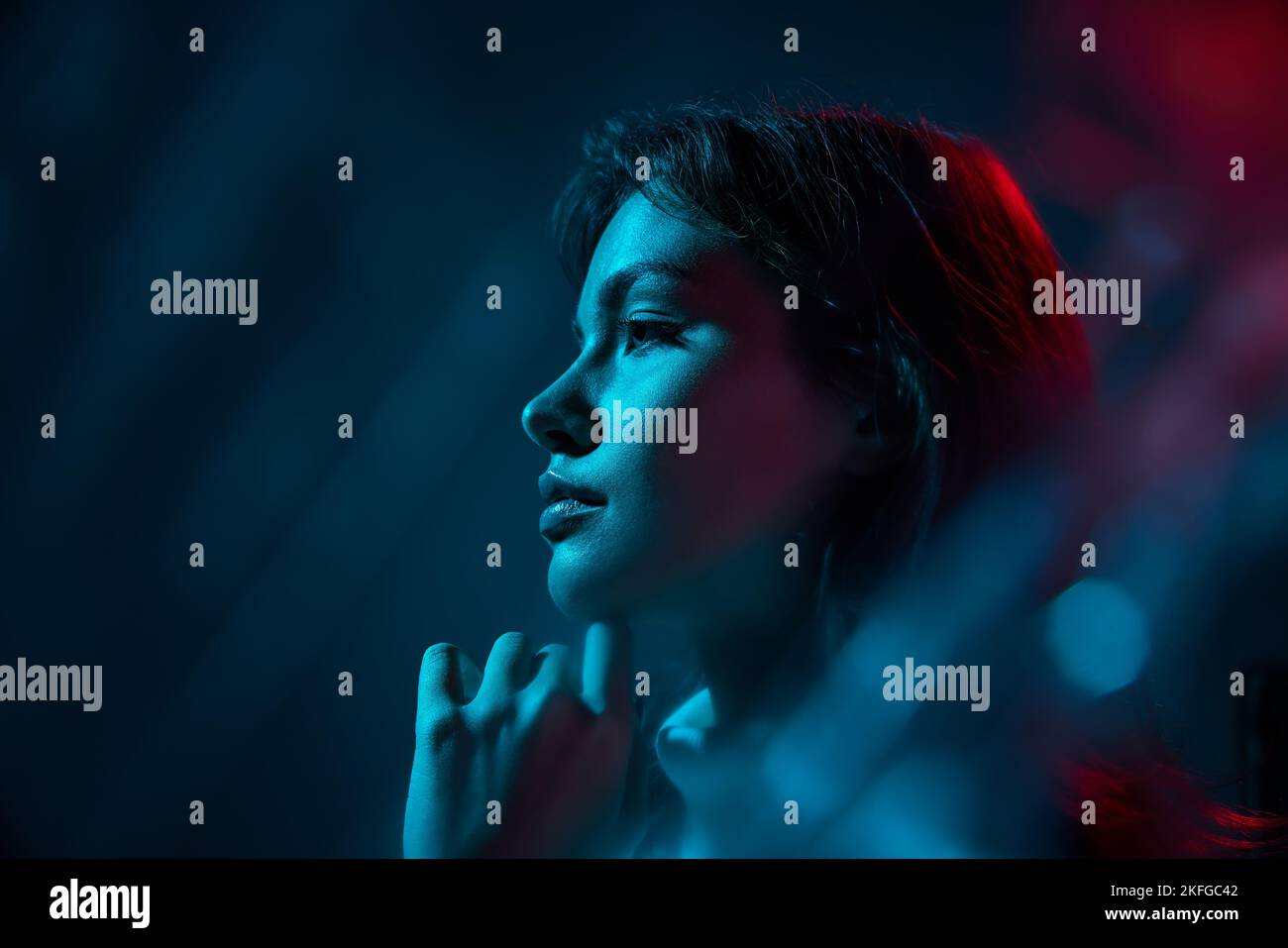 Portrait of young beautiful woman posing isolated over blue studio ...