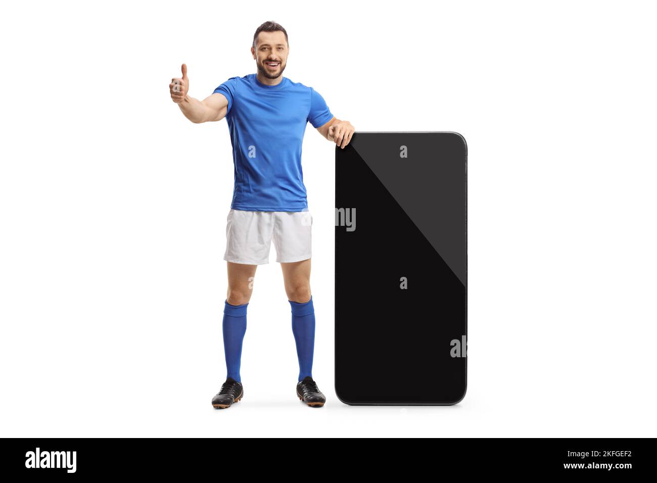 Full length portrait of a football player standing next to a big ...