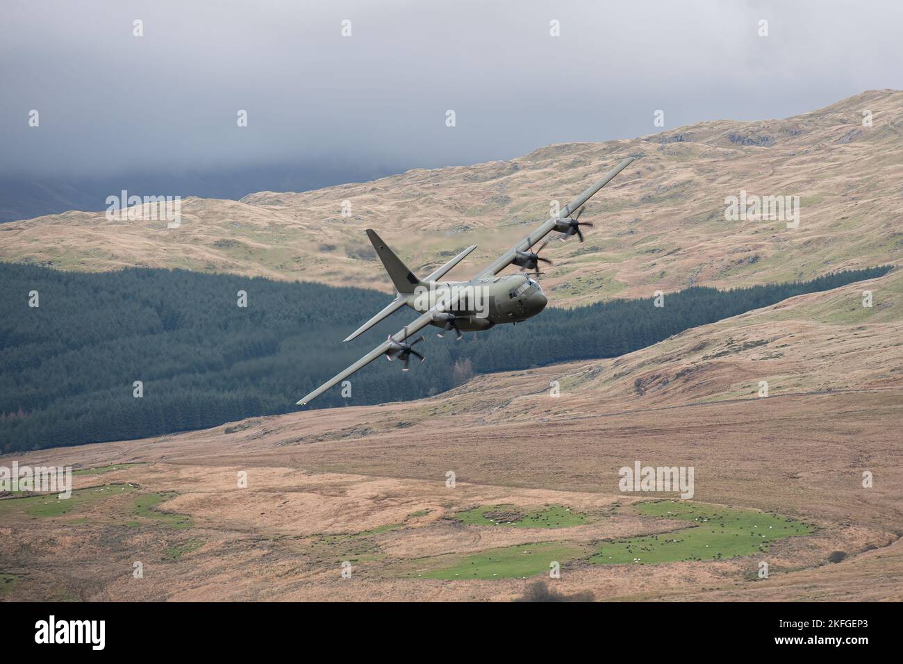 RAF Hercules flying through the Mach Loop at low level with hills and ...