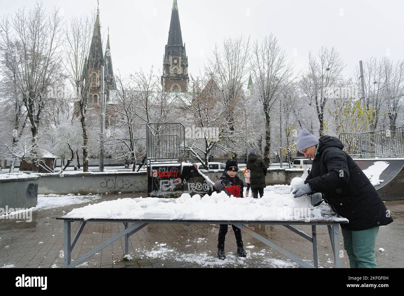 People play in snow in Lviv. The first snow of this season fell at ...