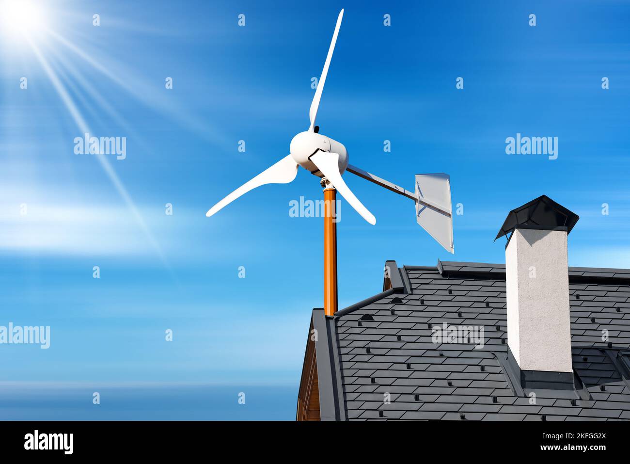 Close-up of a small wind turbine on the top of a roof of a house ...