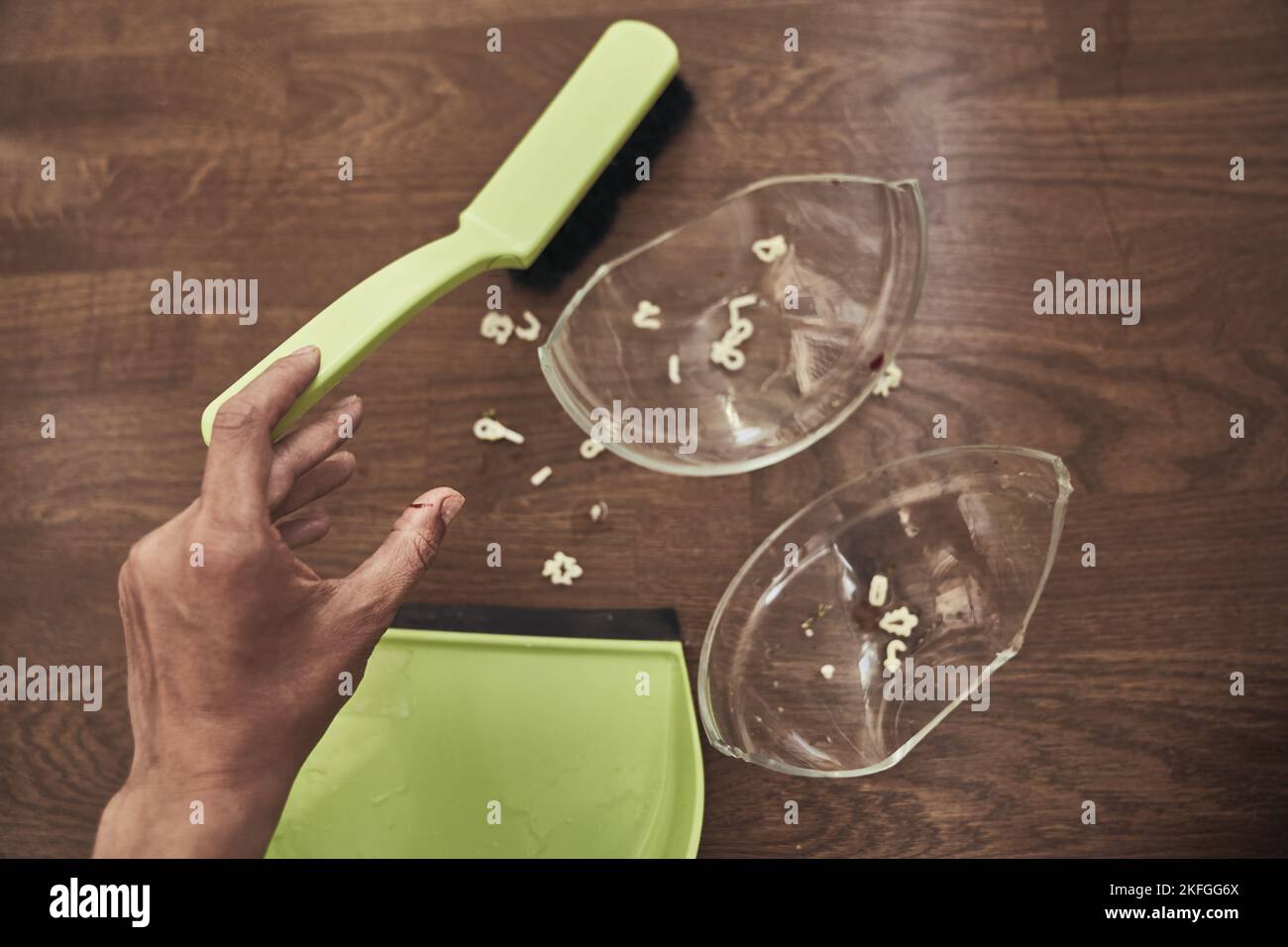 Close-up of a cut female finger on the background of a split cup and a ...