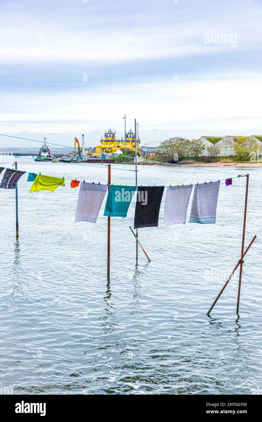 Washing hung out to dry on a line on a pulley system over the River ...