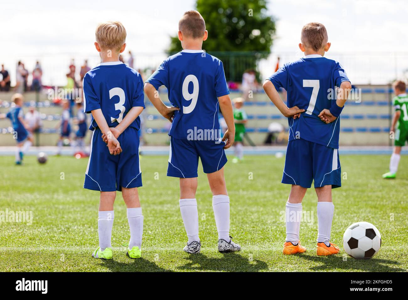 Football soccer match for children. Kids waiting on a pitch sideline ...
