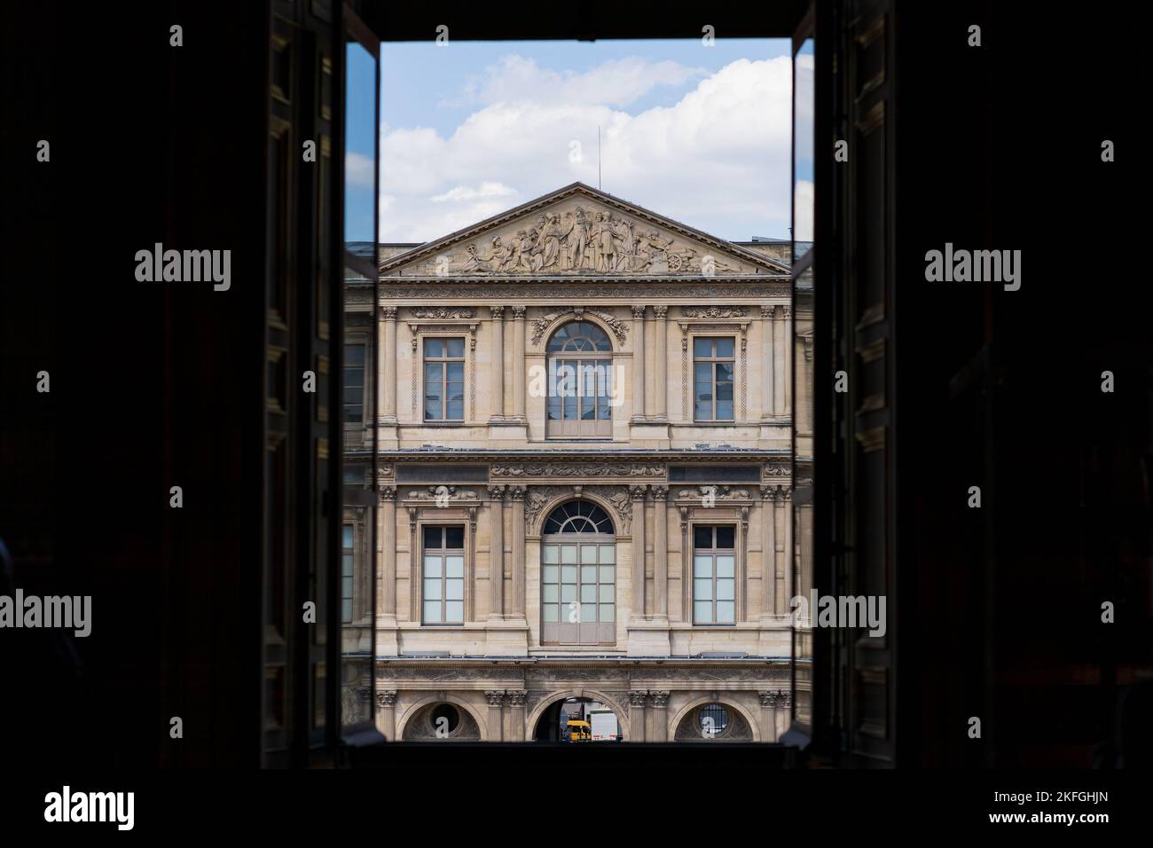 The view from a window to the Louvre Museum historic building in Paris ...