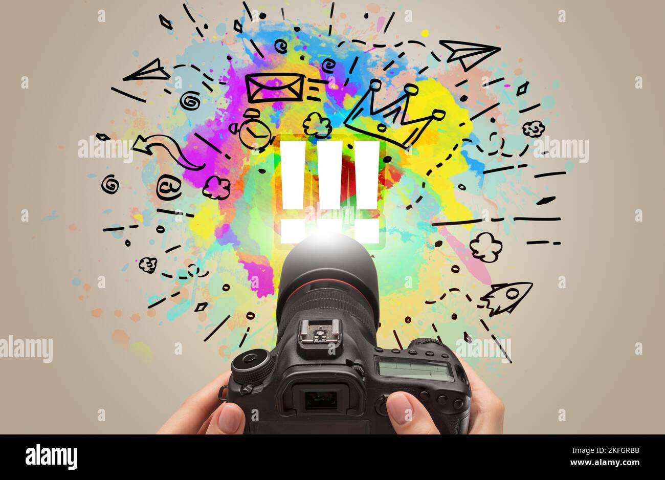 Close-up of a hand holding digital camera with abstract drawing concept ...