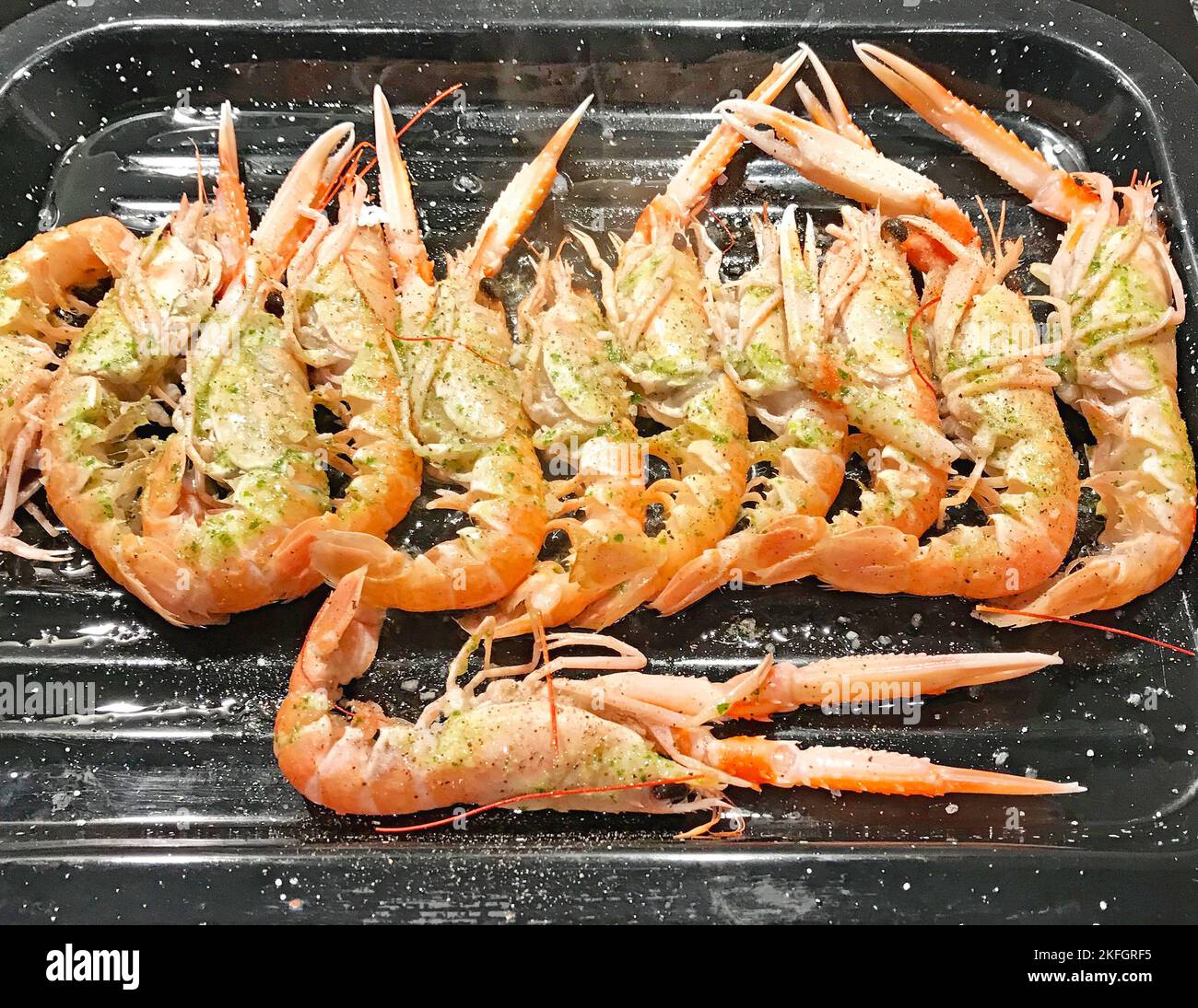 Scampi cooking on a kitchen plate Stock Photo - Alamy