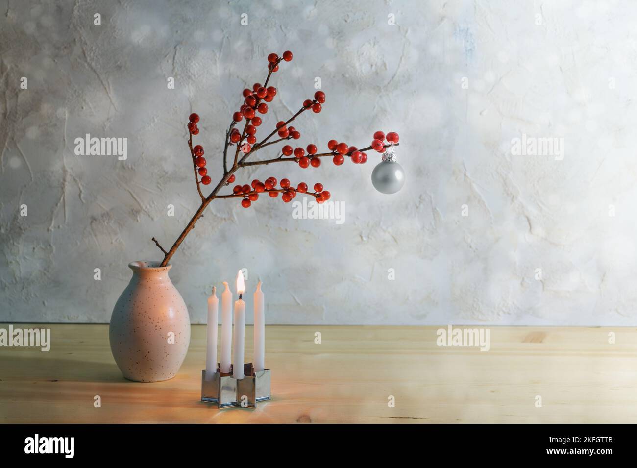 Minimalist first advent with four small candles, one is burning and a ...