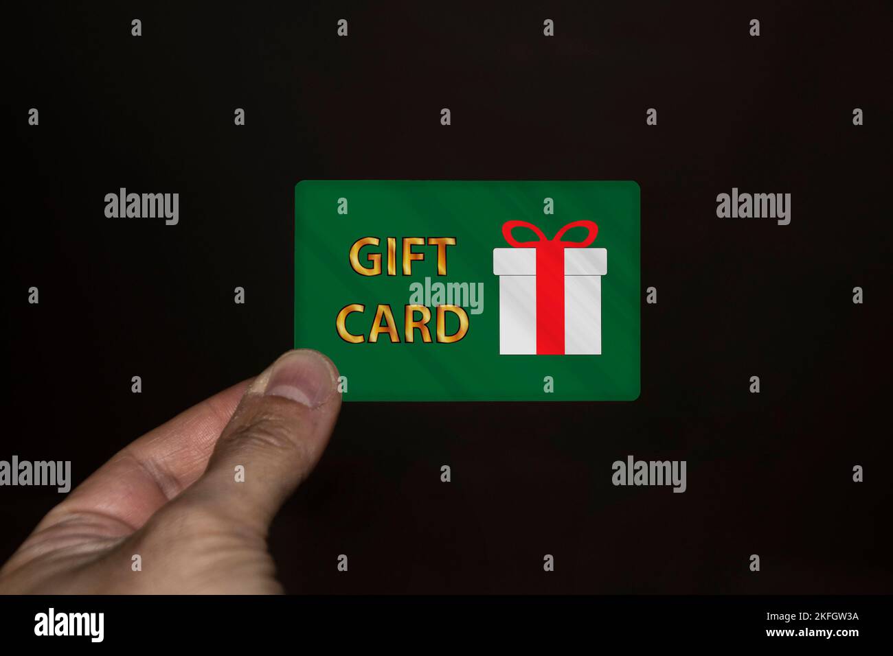 Hand holding a gift card Stock Photo - Alamy