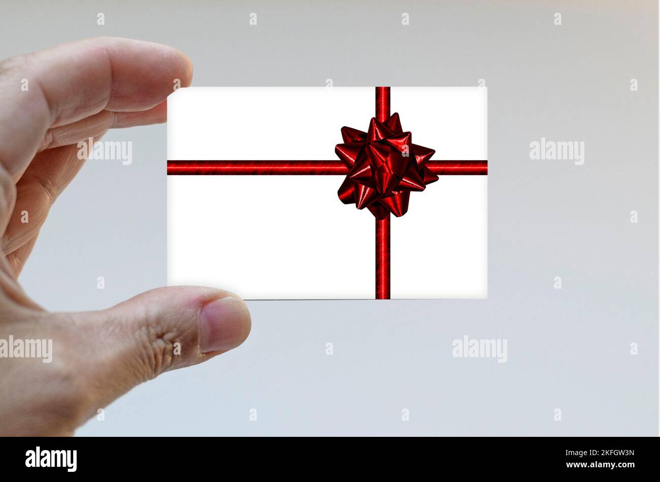 Hand holding a gift card Stock Photo - Alamy