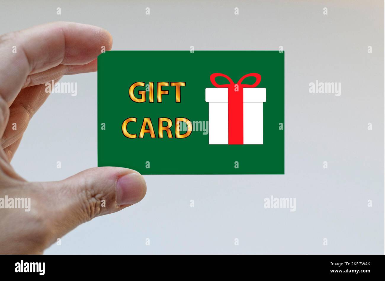 Hand holding a gift card Stock Photo - Alamy