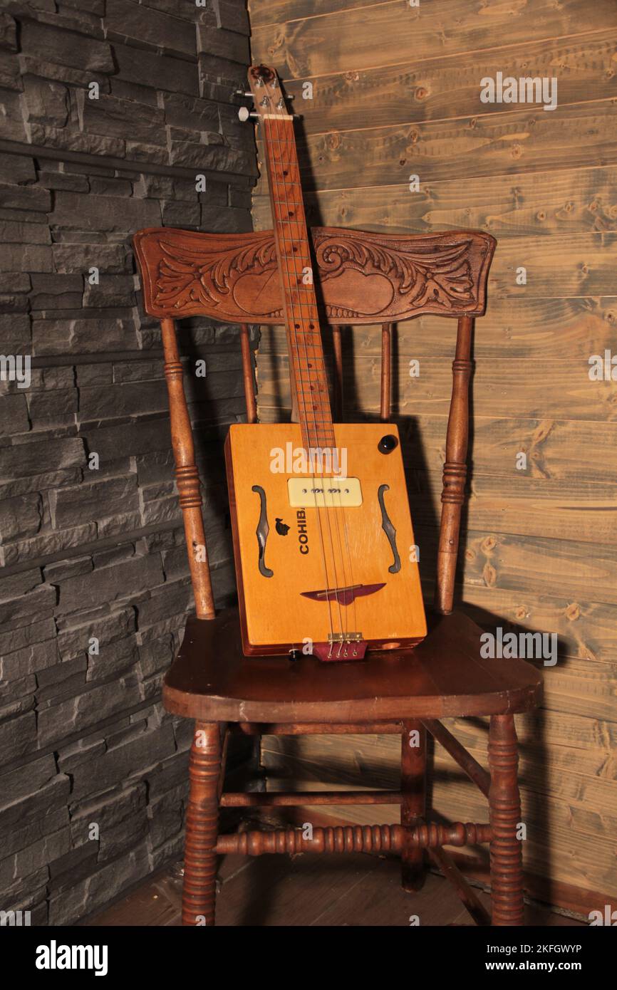 A vertical shot of an ancient guitar made out of a cigar box Stock ...